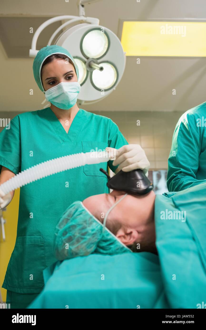 Front view of a nurse holding an oxygen mask Stock Photo - Alamy