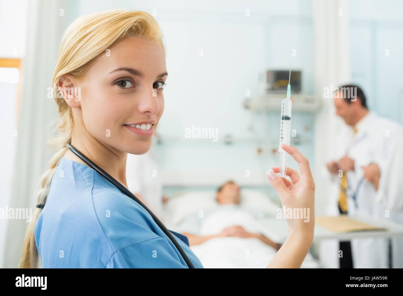 Nurse holding a syringe in hospital ward Stock Photo - Alamy