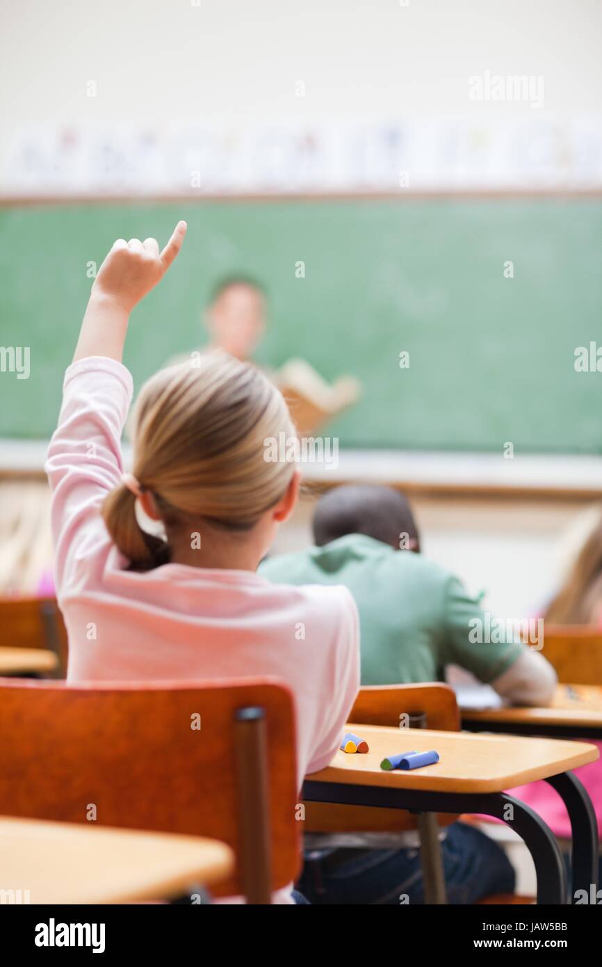 Schoolgirl putting up her hand hi-res stock photography and images - Alamy
