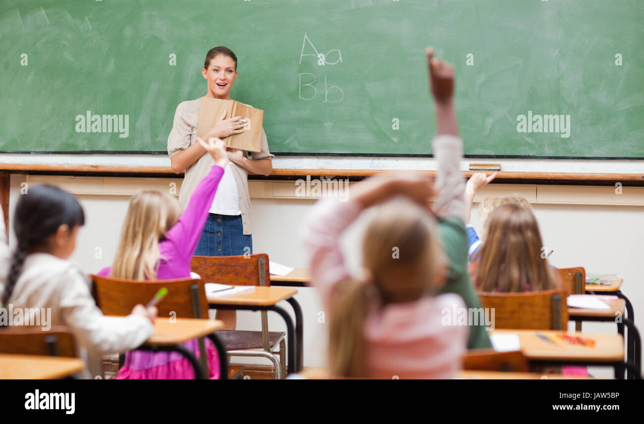 Teacher giving writing class lesson Stock Photo - Alamy