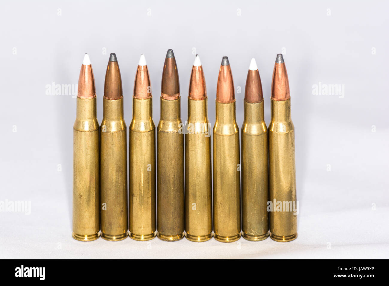 A few rifle bullets lined up in a row on white background Stock Photo ...