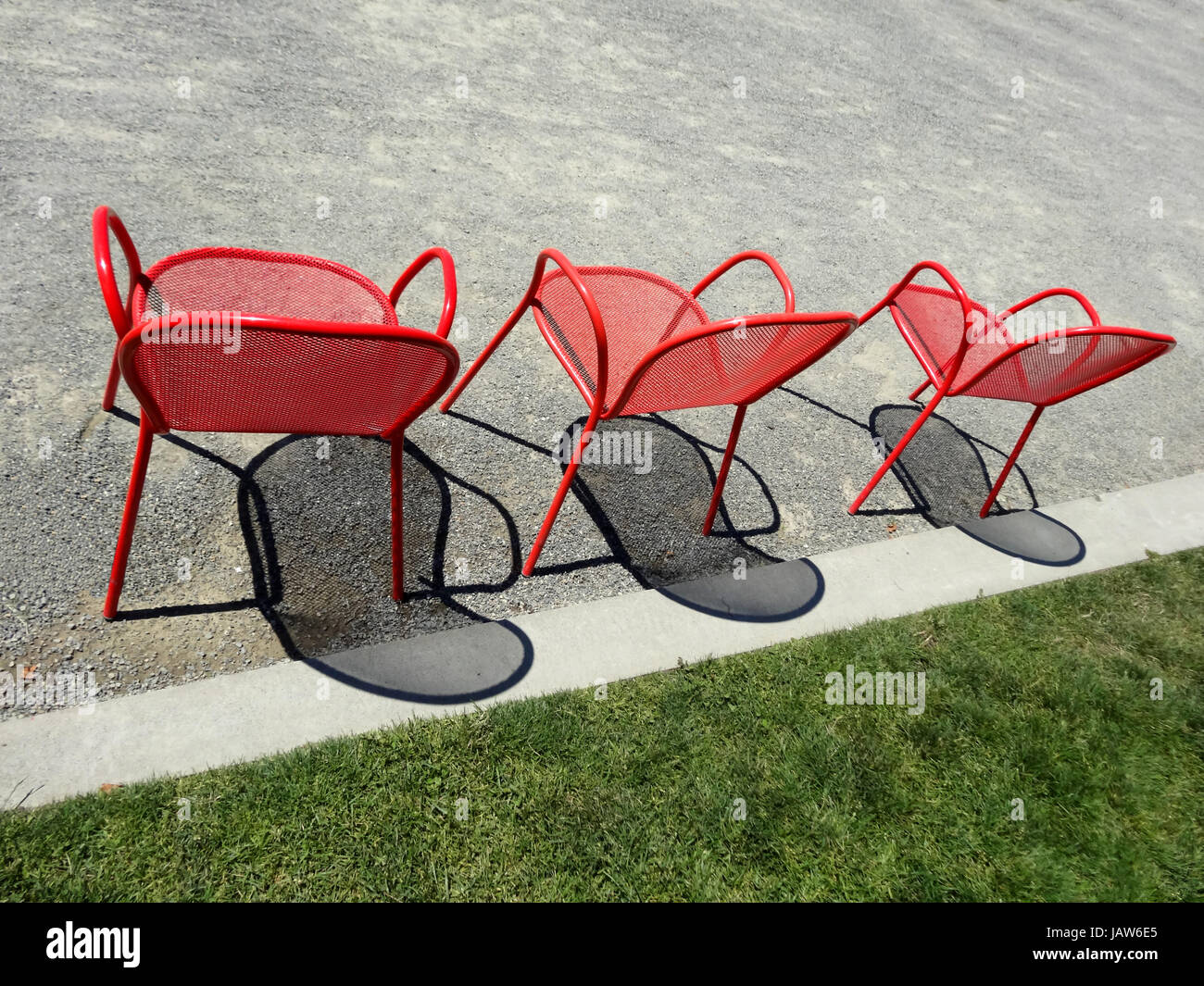 Three empty red chairs in a row from behind Stock Photo - Alamy