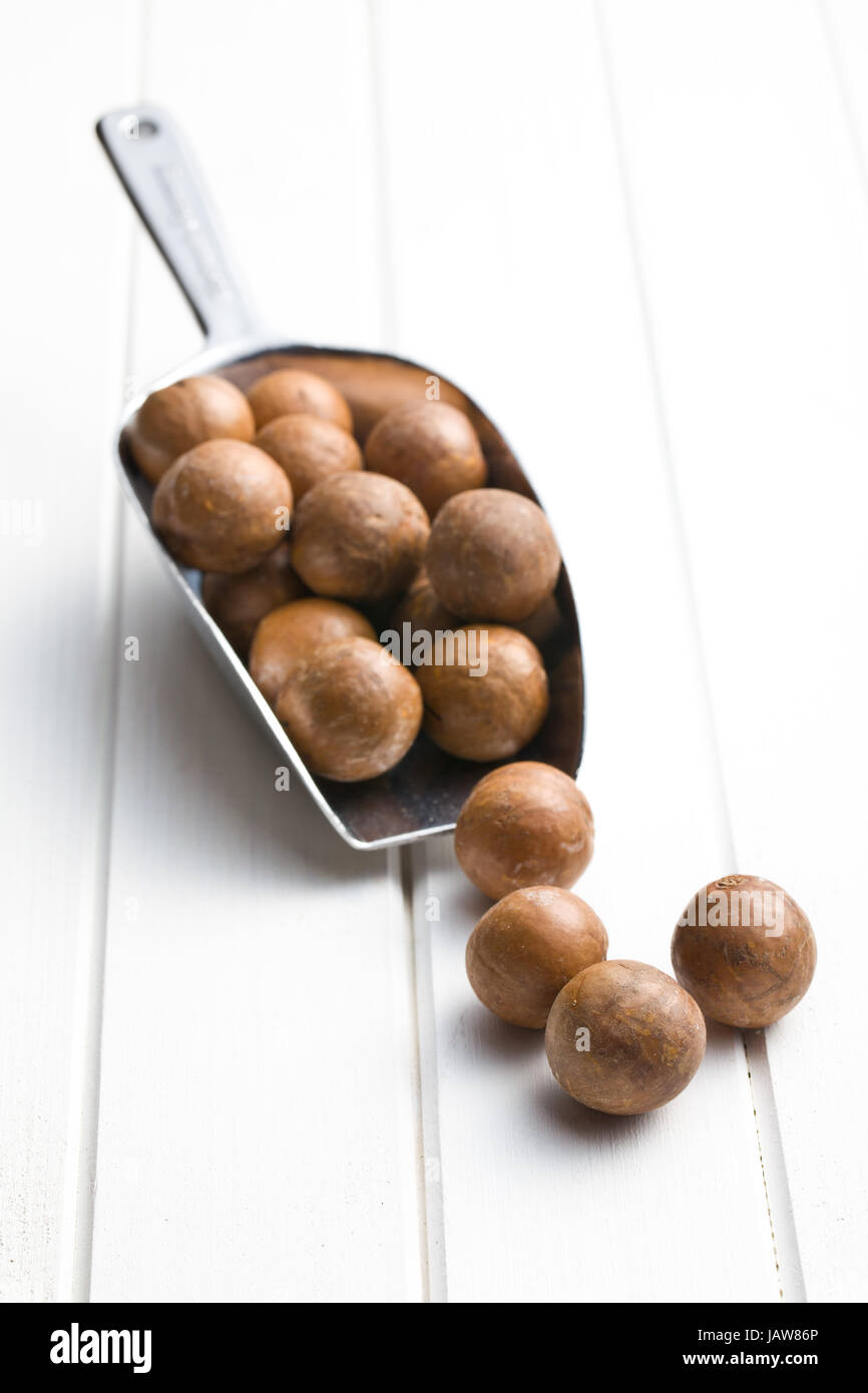 macadamia nuts on scoop on white wooden table Stock Photo - Alamy
