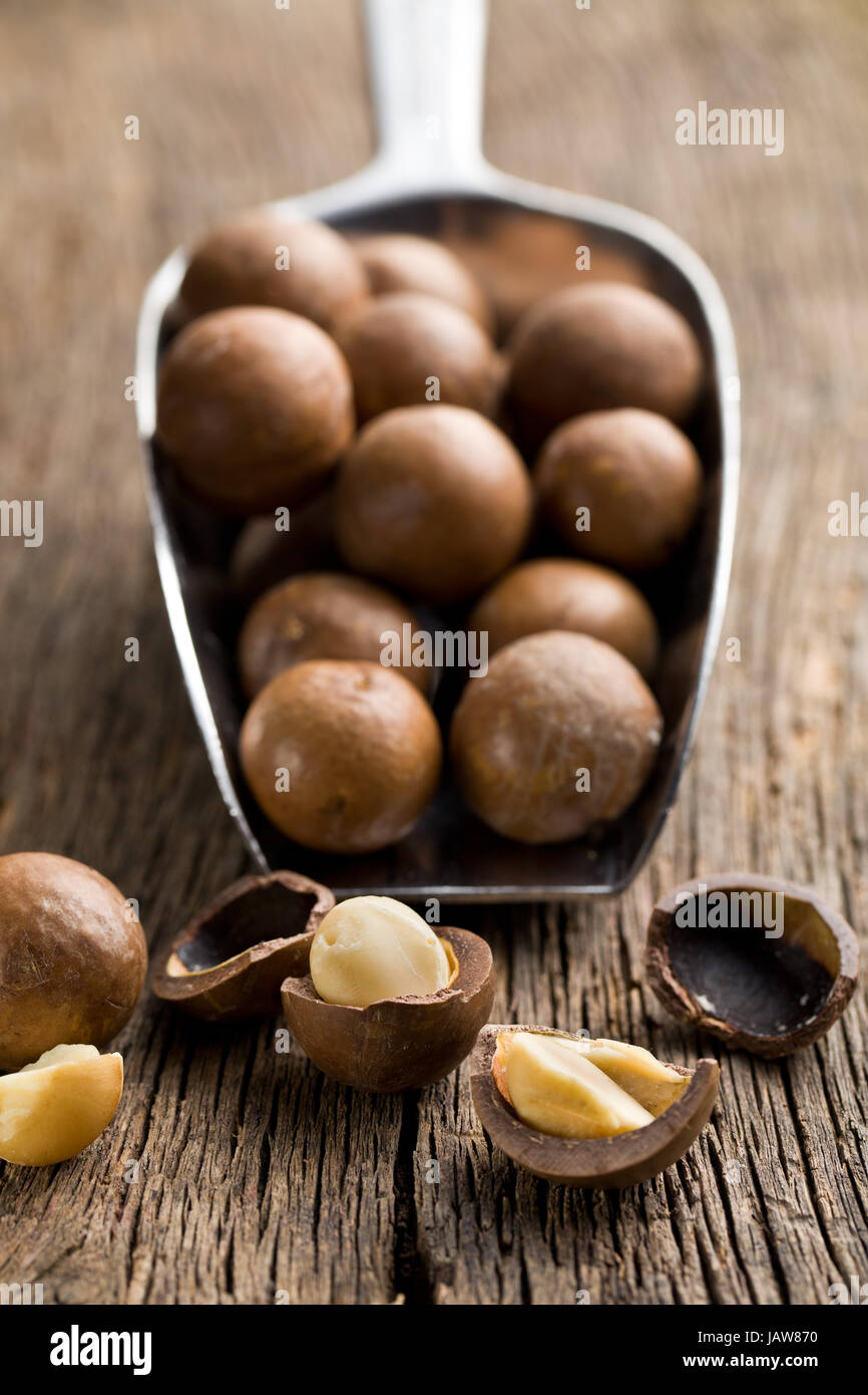 macadamia nuts on scoop on wooden table Stock Photo - Alamy