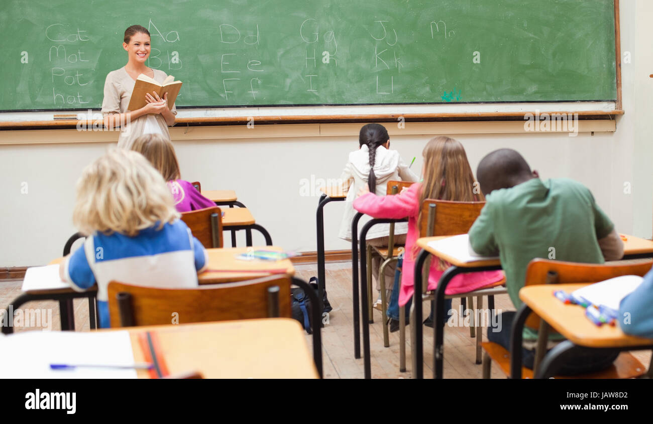 Back view of elementary students during a lesson Stock Photo - Alamy