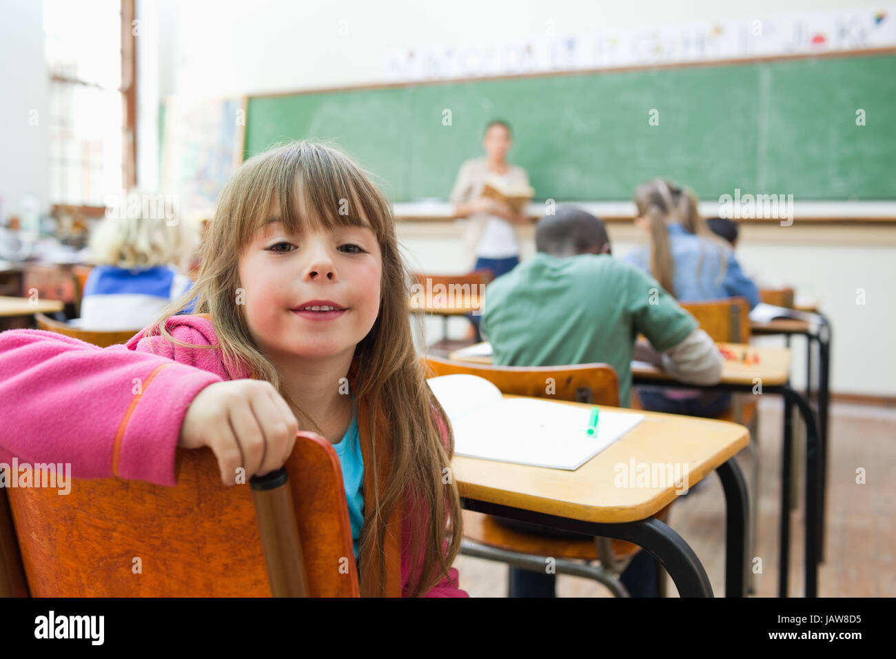 Little girl turning around during lesson Stock Photo - Alamy