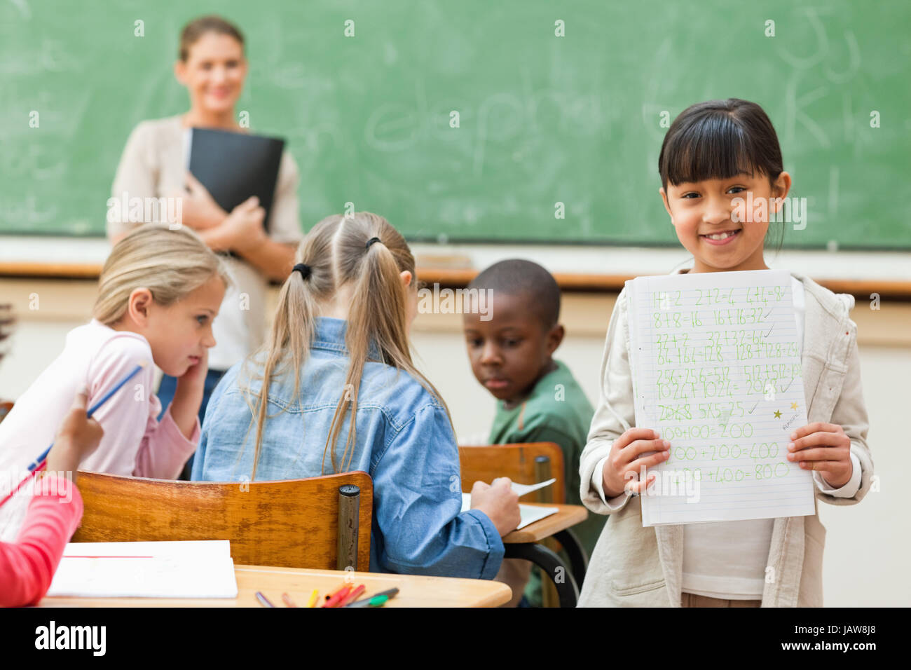 Smiling elementary student with her exercise book Stock Photo - Alamy
