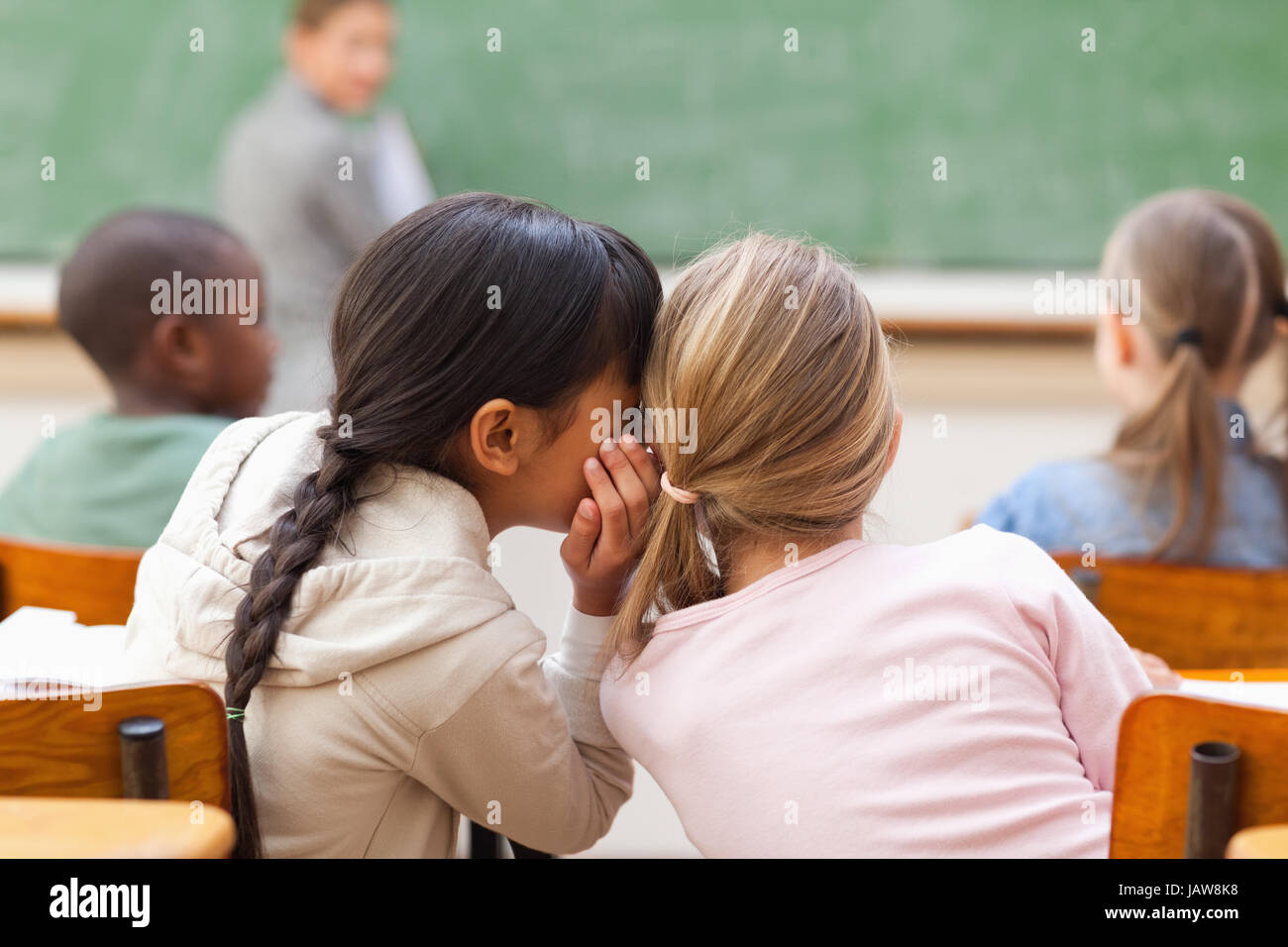 Elementary Students Chatting During Class High Resolution Stock ...