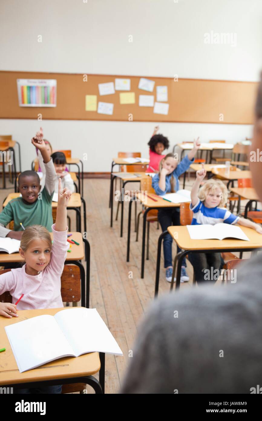 Teacher asking a question to her class Stock Photo - Alamy