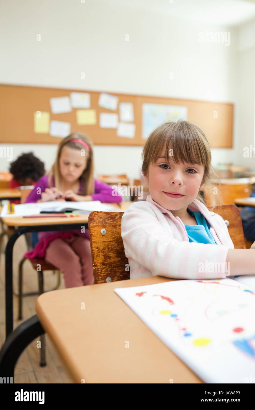 Girl at desk with drawing book Stock Photo - Alamy