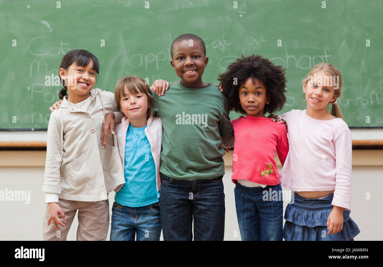 Elementary students standing in front of blackboard Stock Photo - Alamy