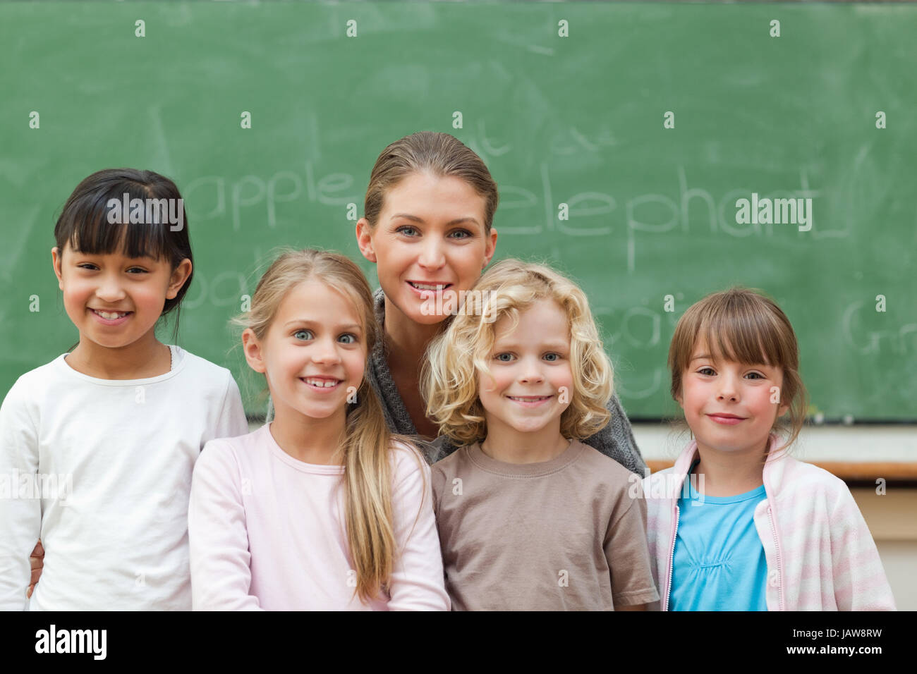 Elementary teacher with her students in front of blackboard Stock Photo ...