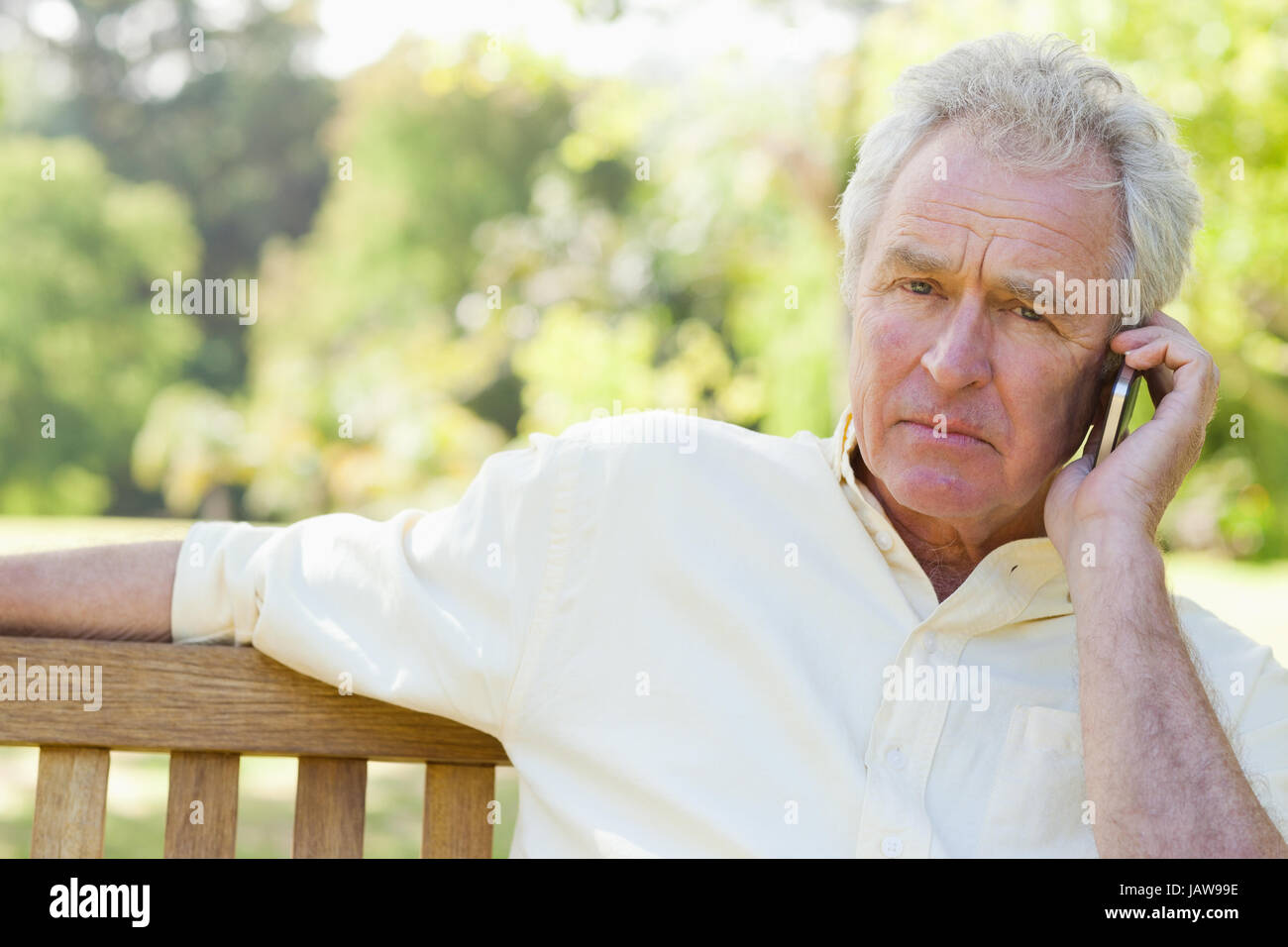 Man with a serious expression making a call Stock Photo - Alamy