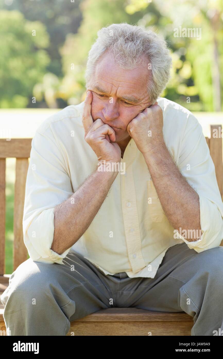 Man with a disappointed expression resting his face in his hands Stock ...