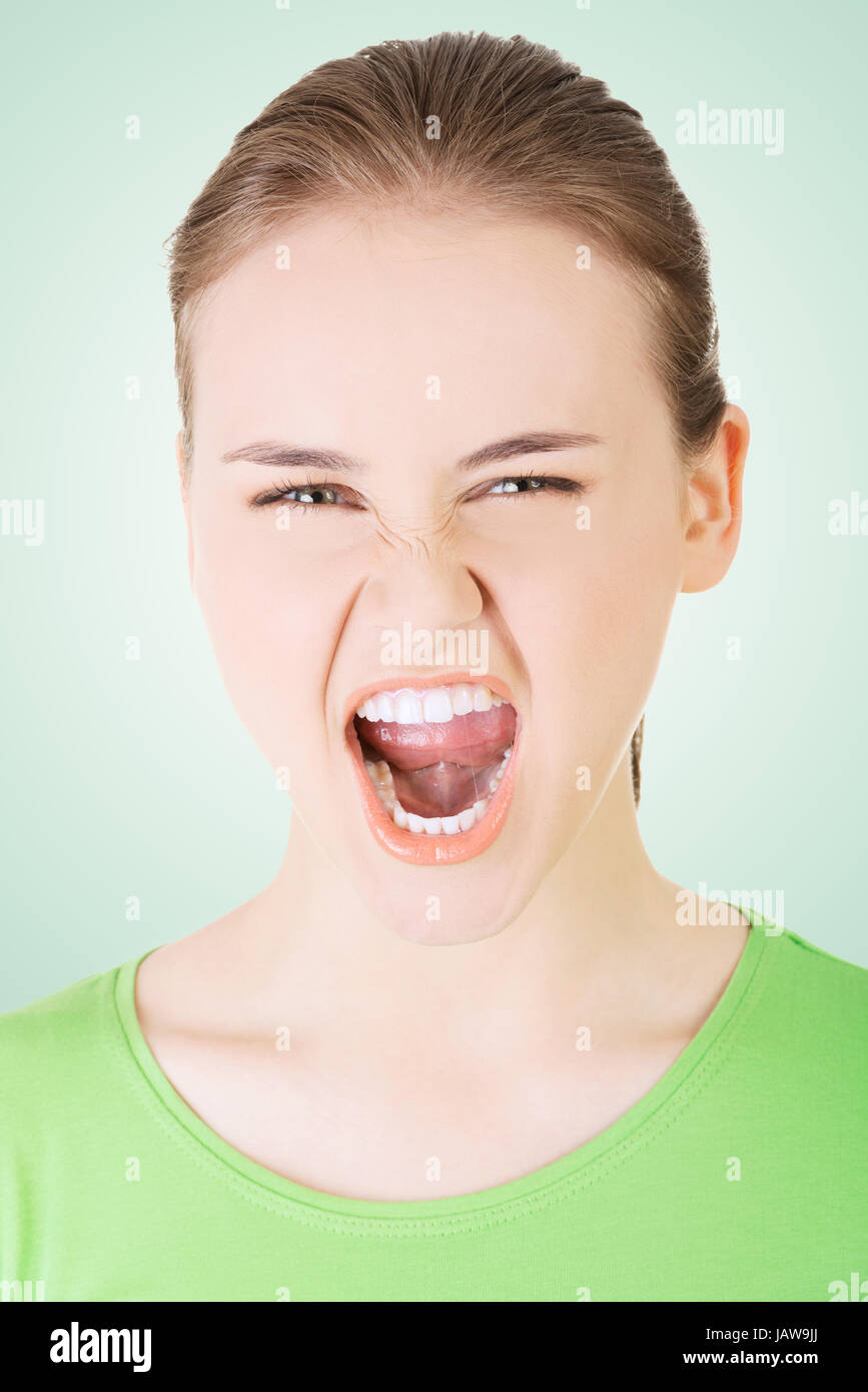 Young casual woman screaming with anger Stock Photo - Alamy