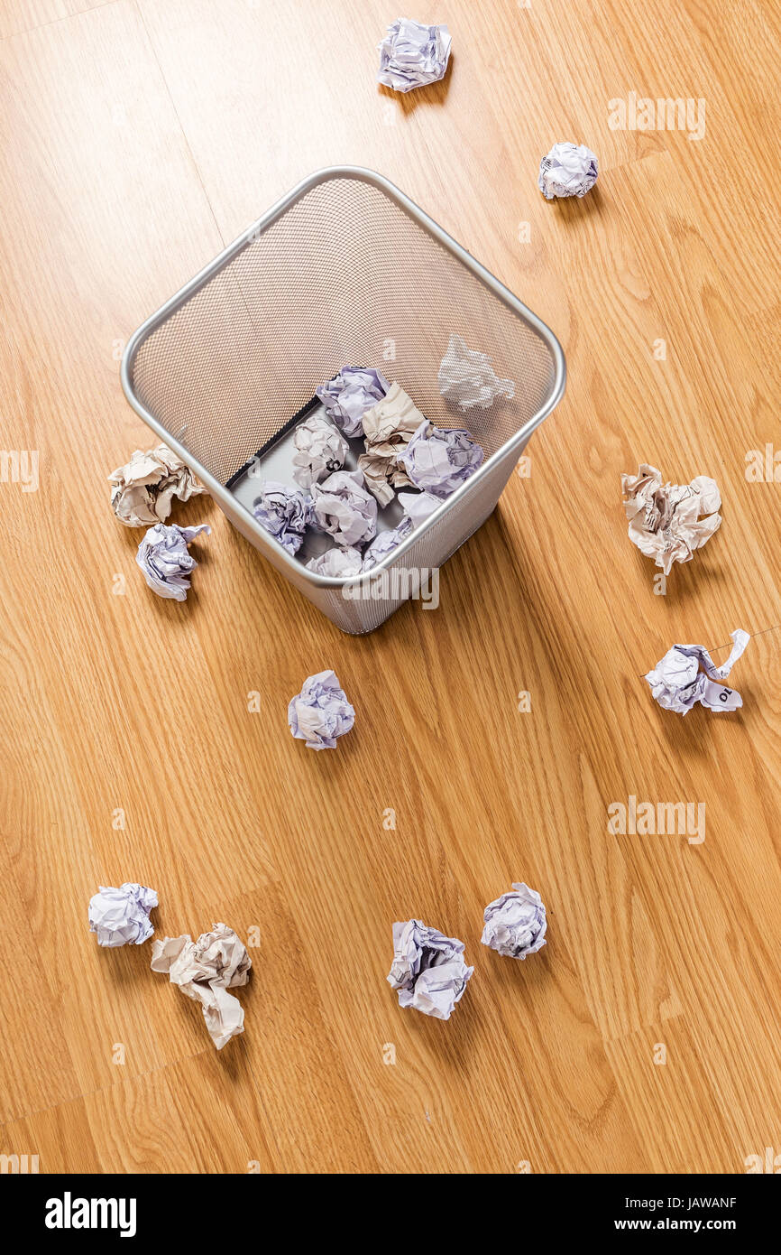 Trash bin and paper ball Stock Photo - Alamy