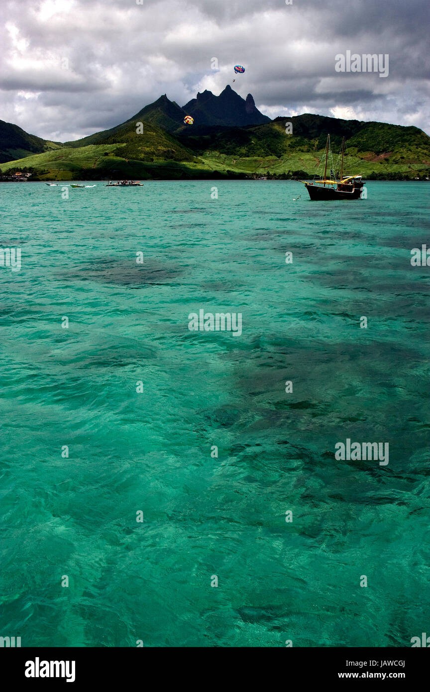 tropical lagoon hill navigable froth cloudy pirate boat and coastline ...