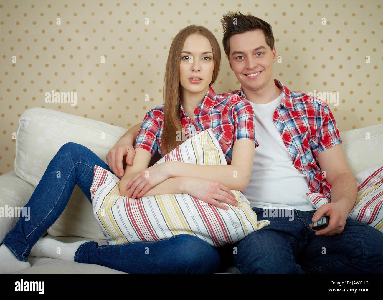 Portrait of young couple during watching TV Stock Photo - Alamy