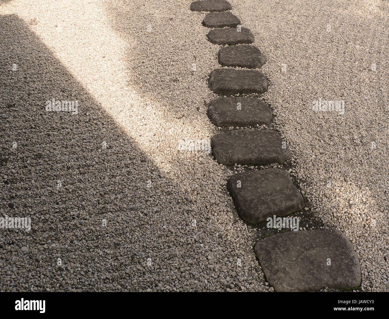 stone way in japanese stone garden with temple's roof shadow Stock ...
