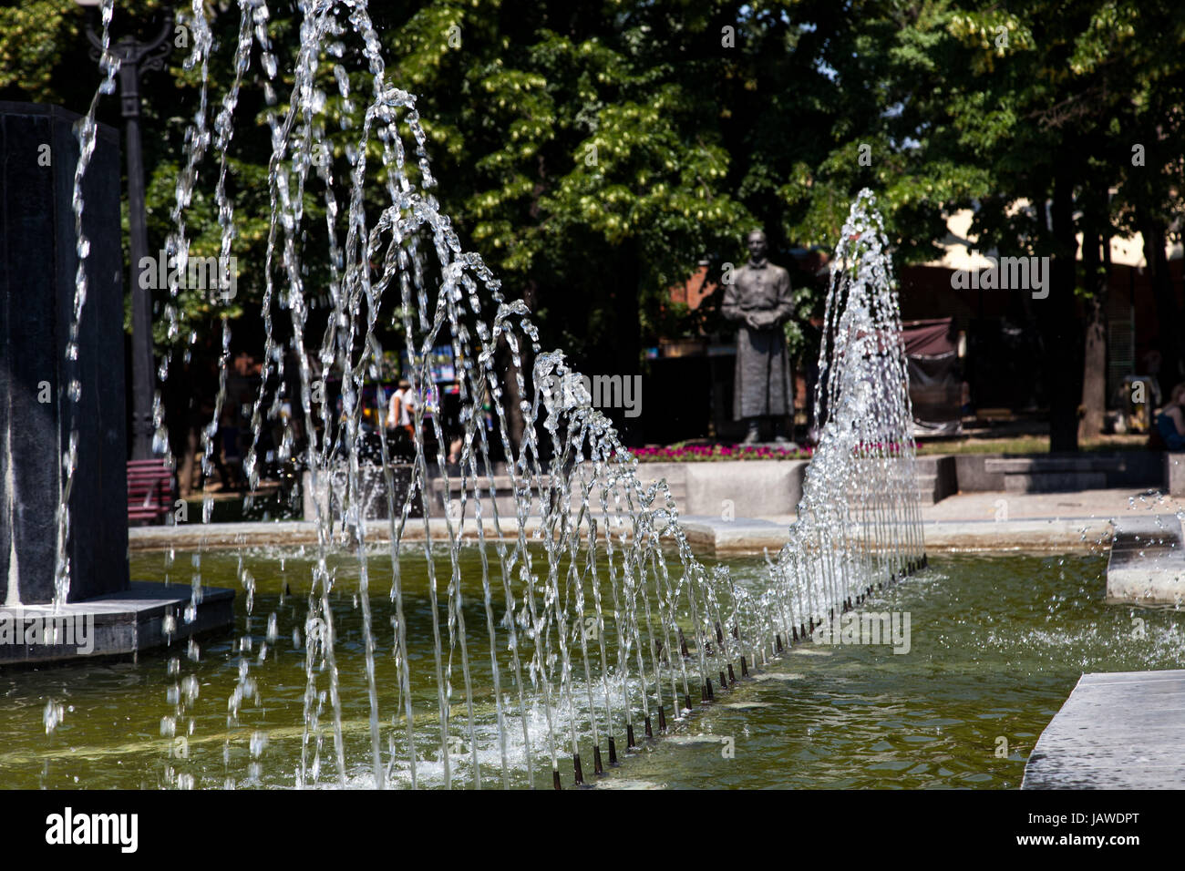 Pretty fountain in a park with splashing water Stock Photo - Alamy