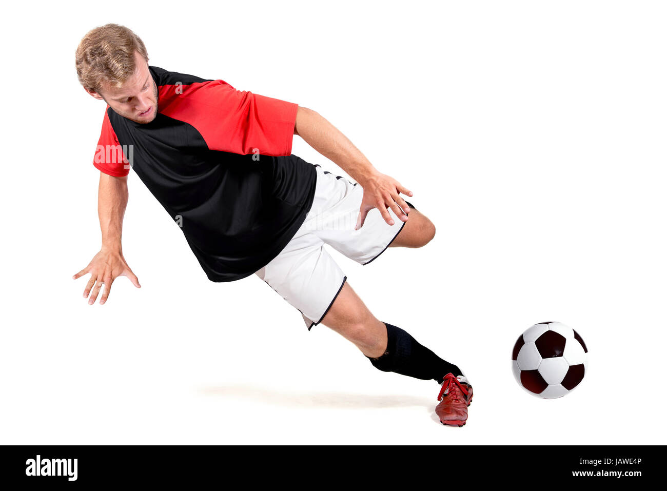 Football player kicking a ball isolated in white Stock Photo - Alamy