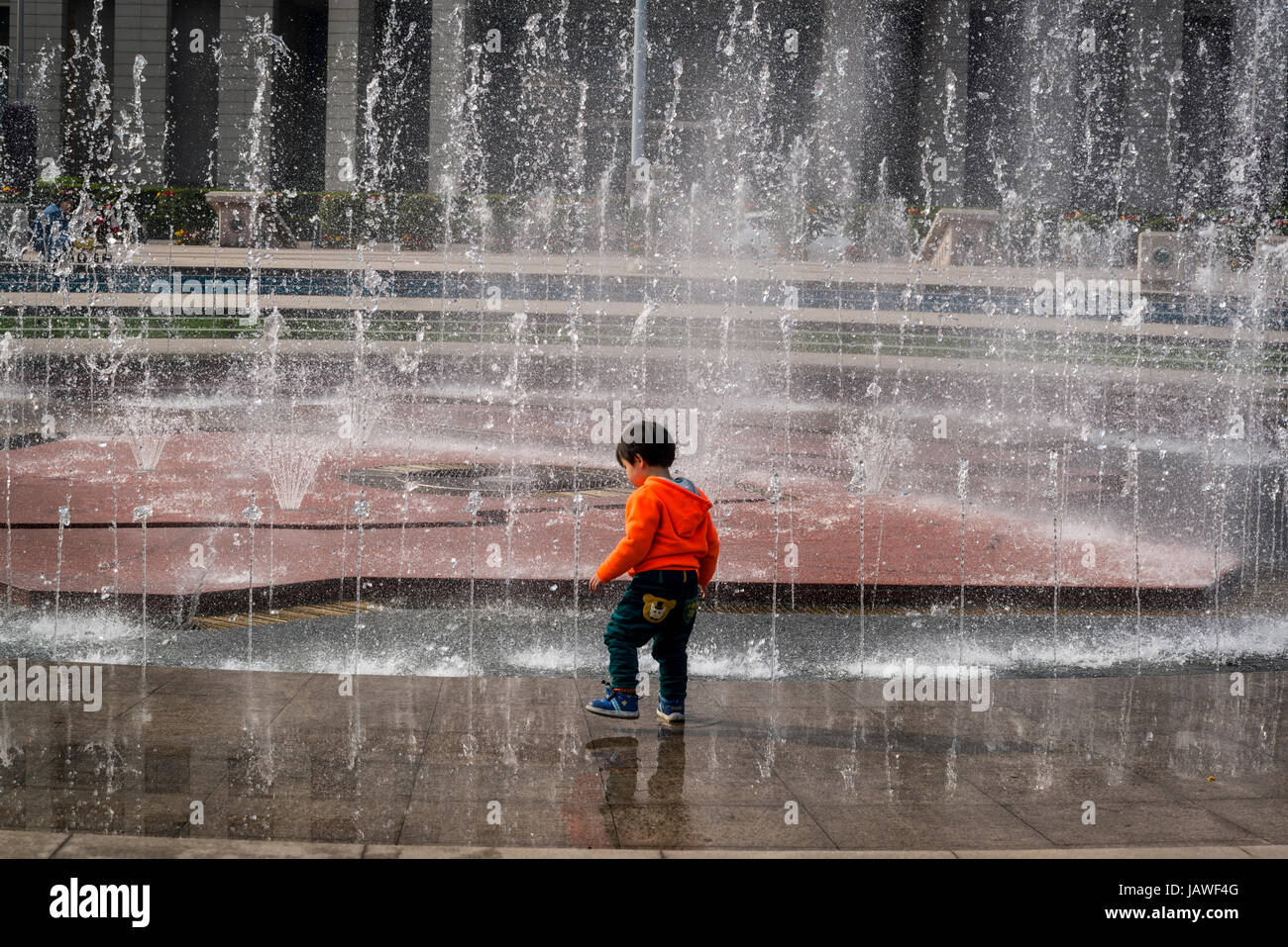 Little boy playing in the fountain, People's Square (Renmin Guang Chang ...