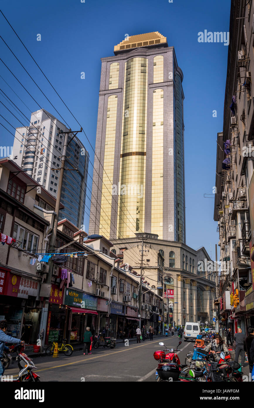 New shiny skyscraper towering over the old ramshackle neighbourhood in ...