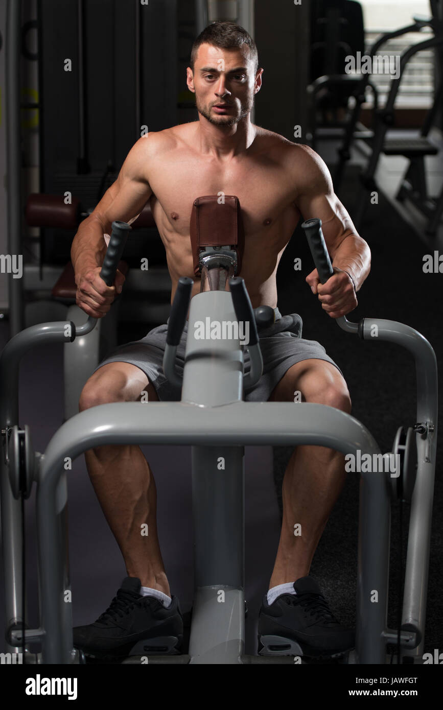 Muscular Man Doing Heavy Weight Exercise For Back On Machine Stock ...