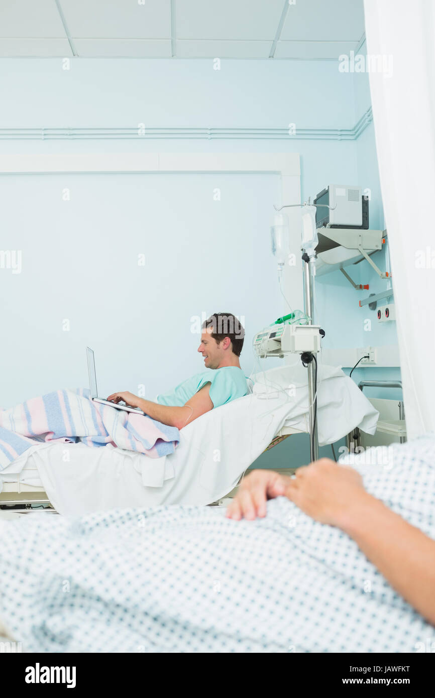 Hospital patient bed laptop typing hi-res stock photography and images ...