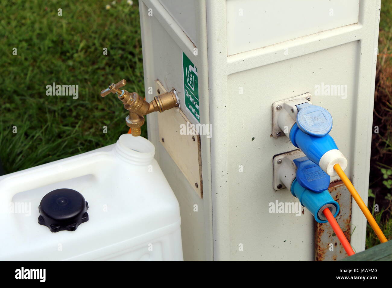 Filling a drinking water container at a campsite water and electricity ...