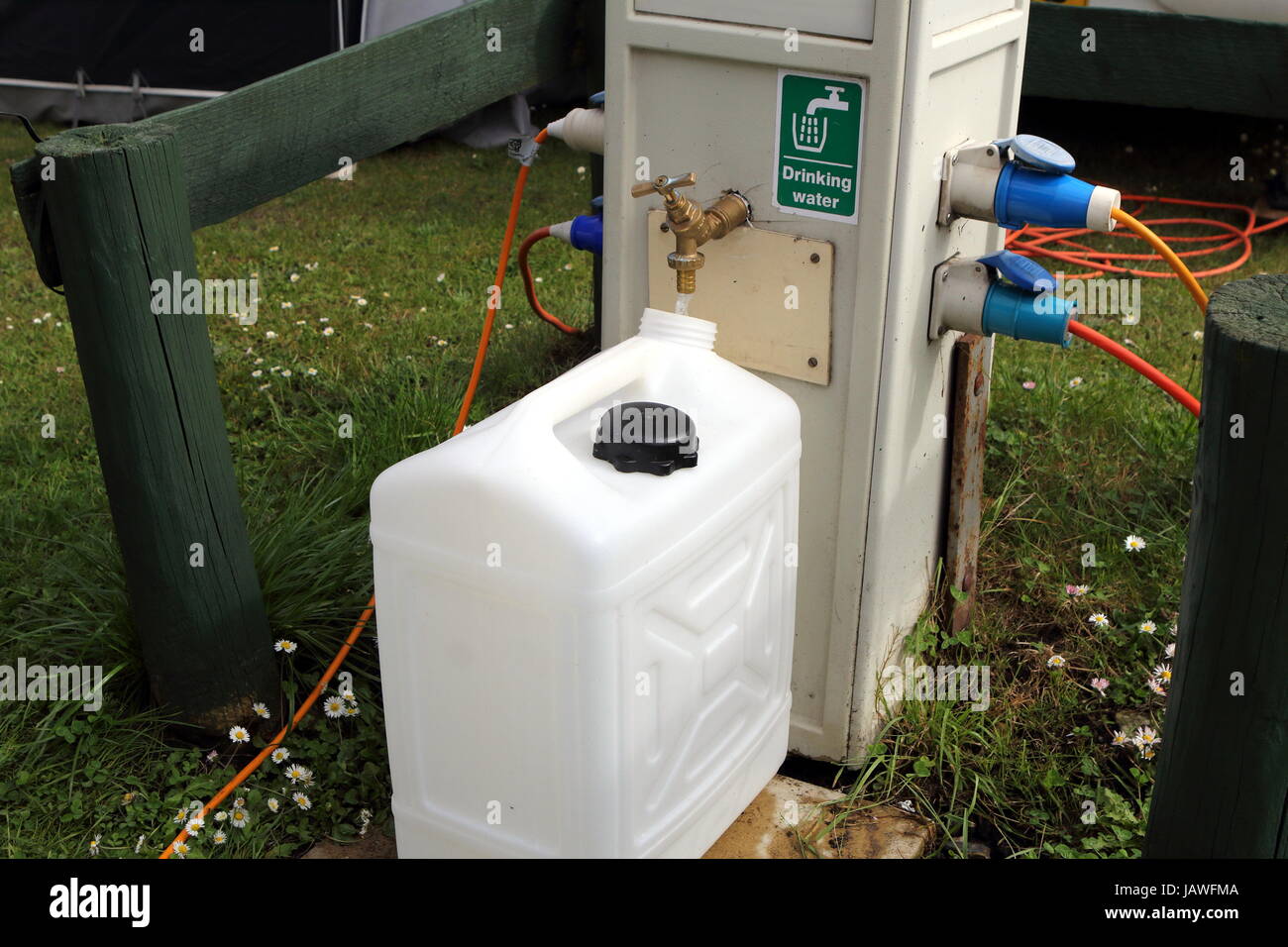 Filling a drinking water container at a campsite water and electricity ...