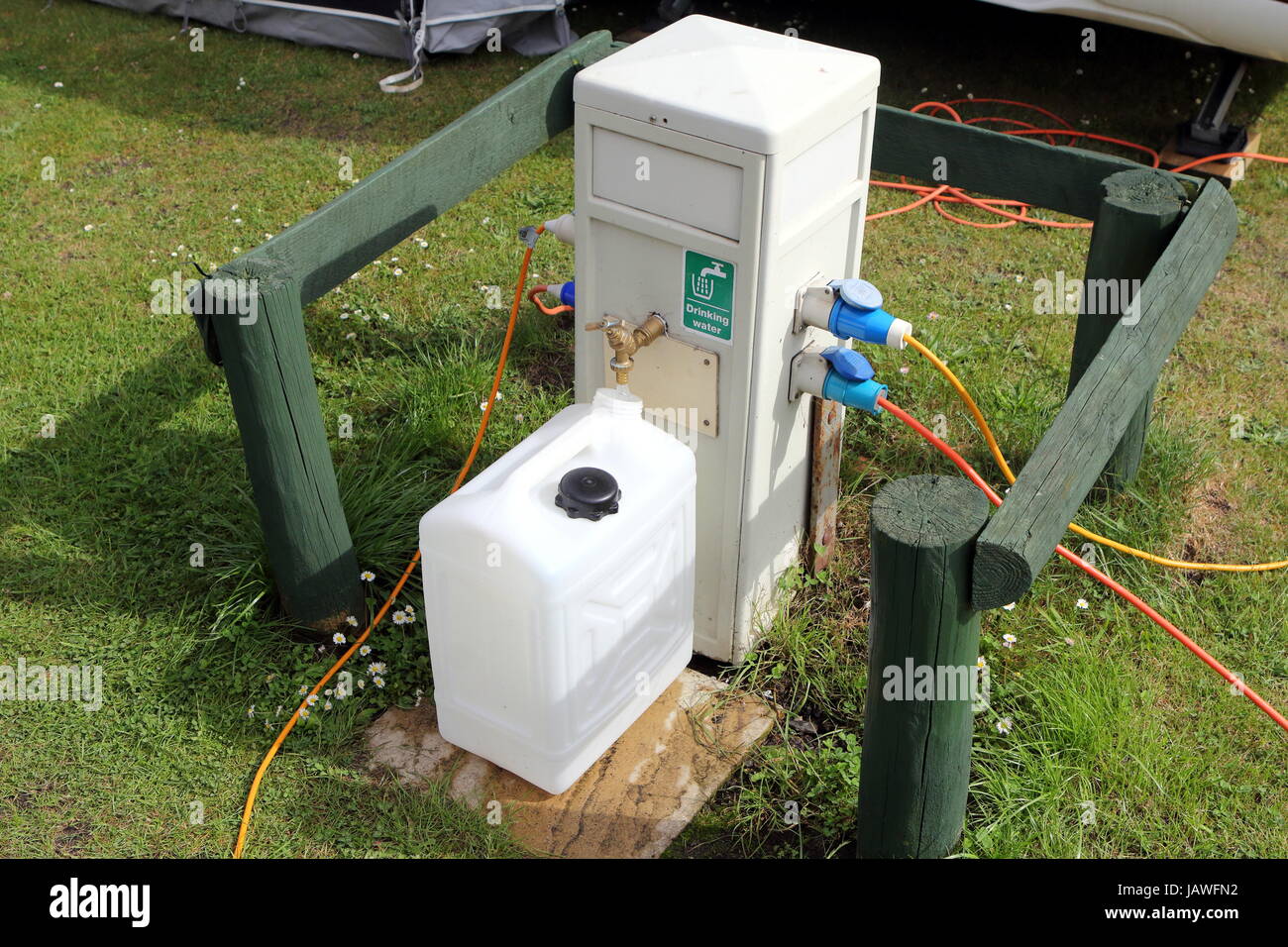 Filling a drinking water container at a campsite water and electricity ...