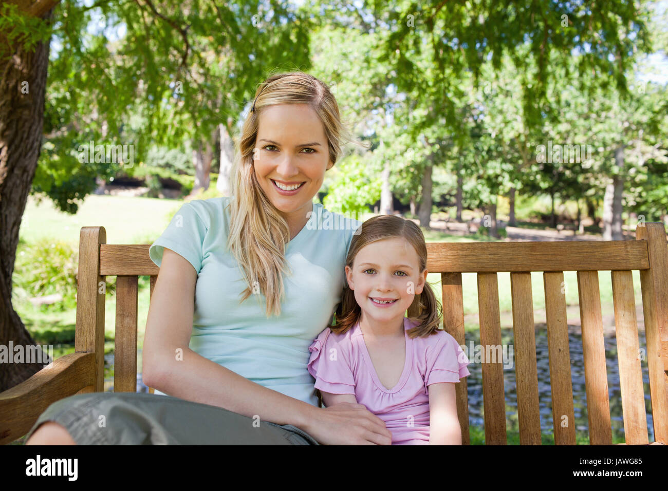 Mother and daughter sit on the bench together Stock Photo - Alamy