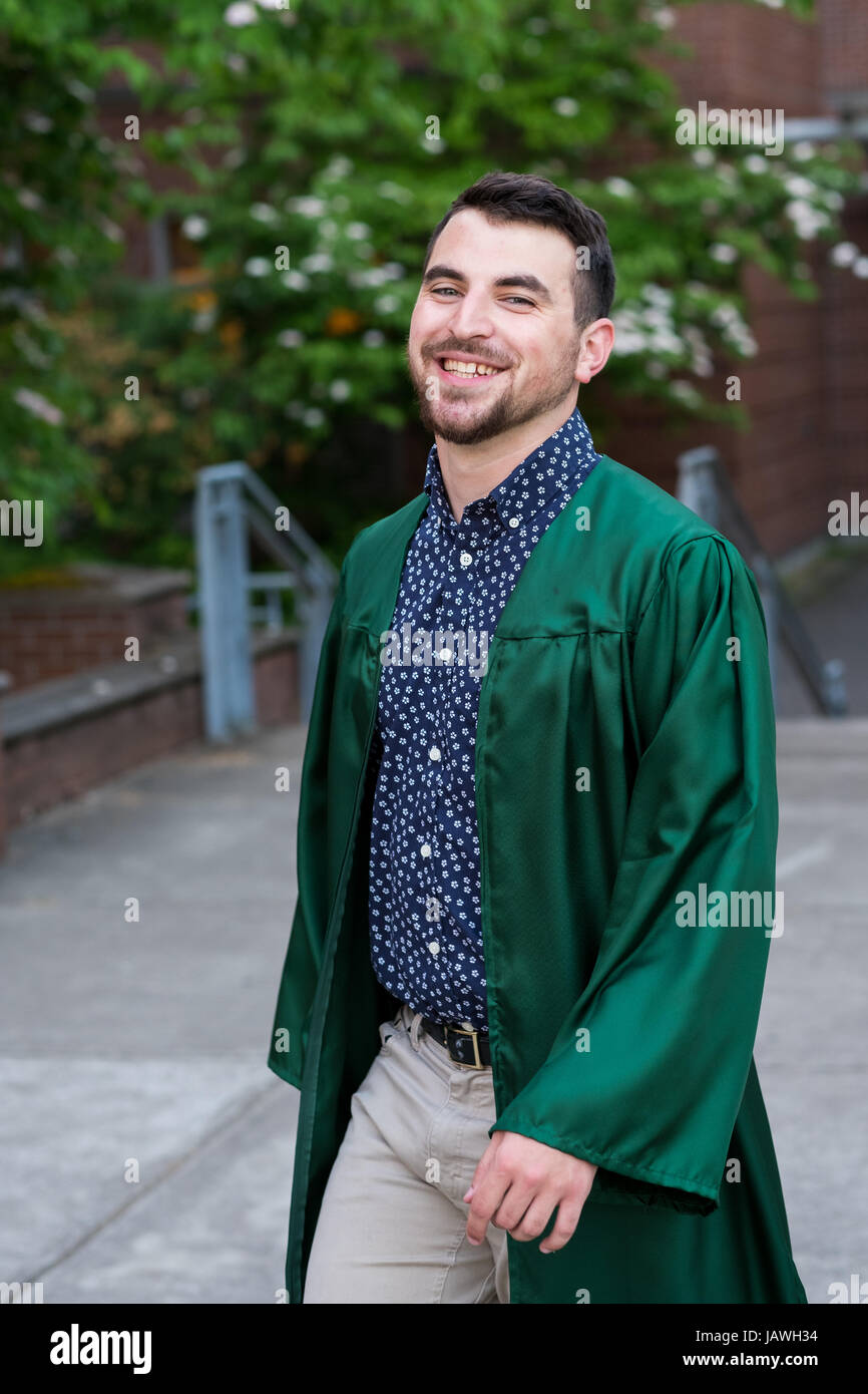 Male model wearing a graduation gown on campus at a university in ...