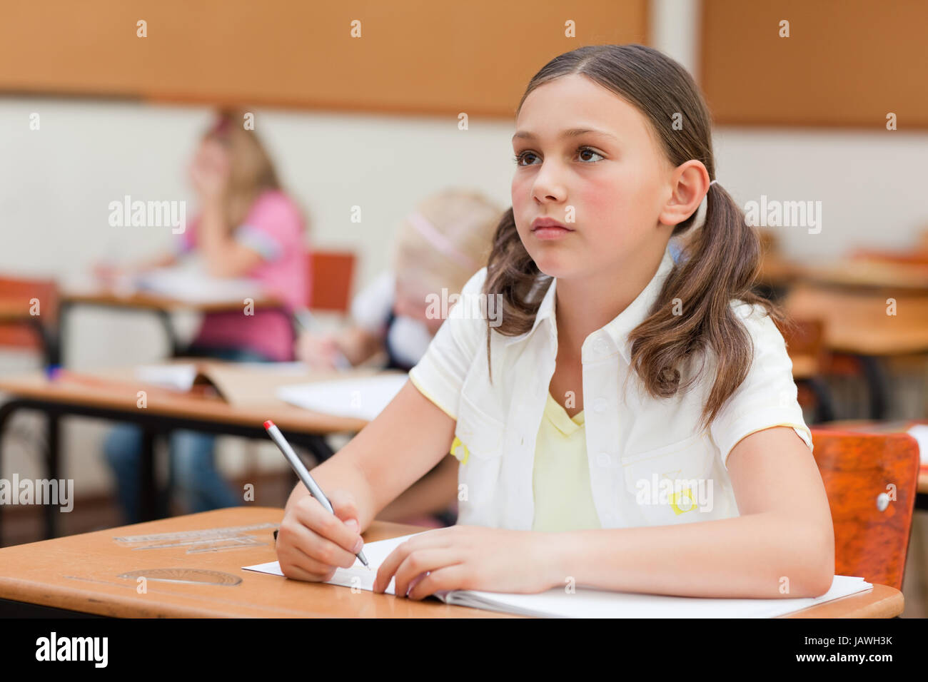 Student listening to teacher Stock Photo - Alamy