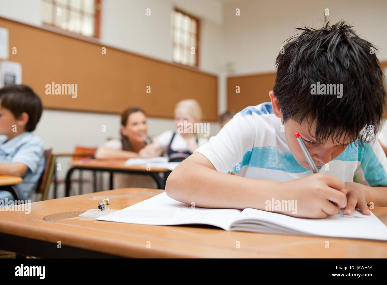 Student working focused on his exercises Stock Photo - Alamy