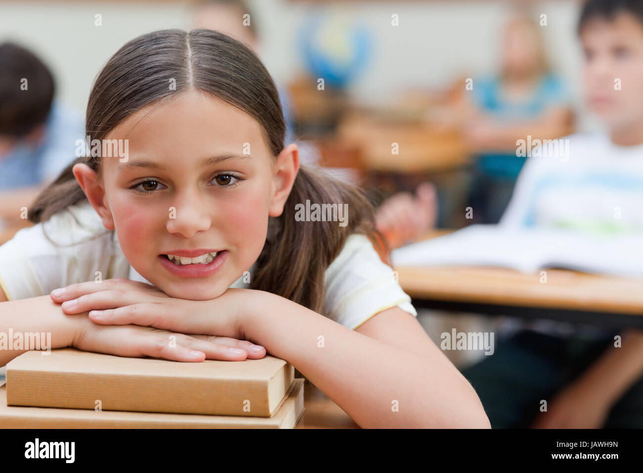 Girl sitting on pile of books reading hi-res stock photography and ...