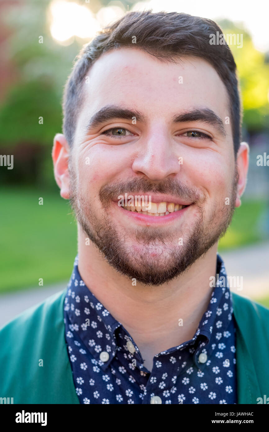 Male model wearing a graduation gown on campus at a university in ...