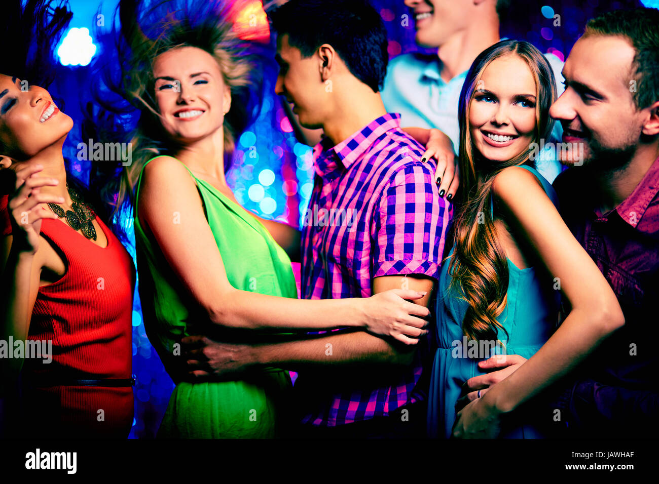 Happy young friends dancing in the nightclub Stock Photo - Alamy