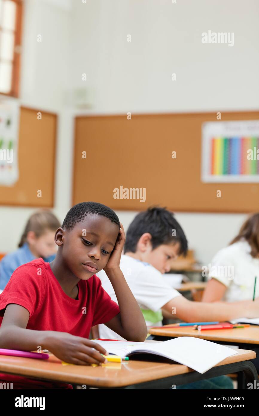 Side view of bored student during class Stock Photo - Alamy