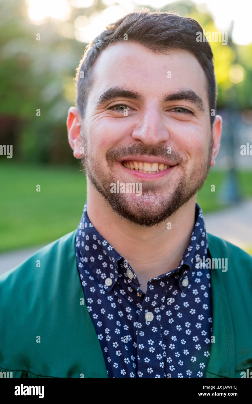 Male model wearing a graduation gown on campus at a university in ...