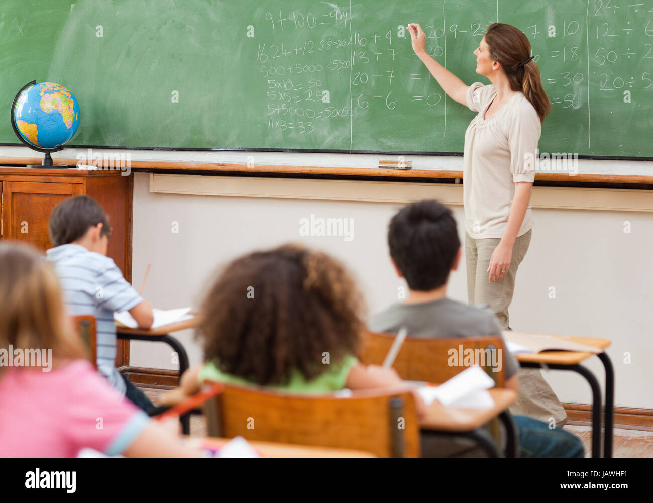 Teacher giving math lesson Stock Photo - Alamy