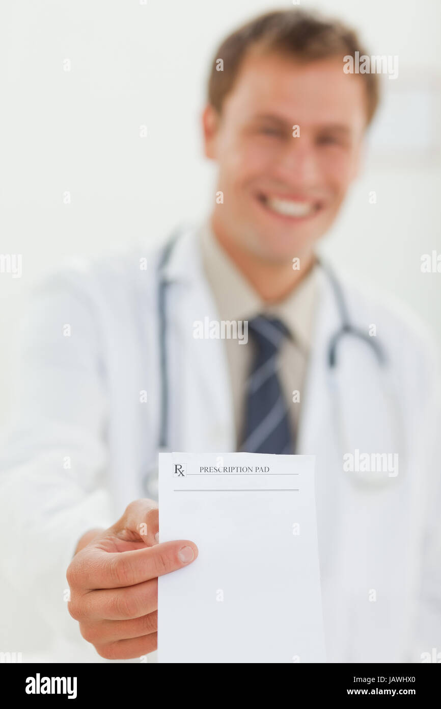 Smiling doctor showing prescription Stock Photo - Alamy