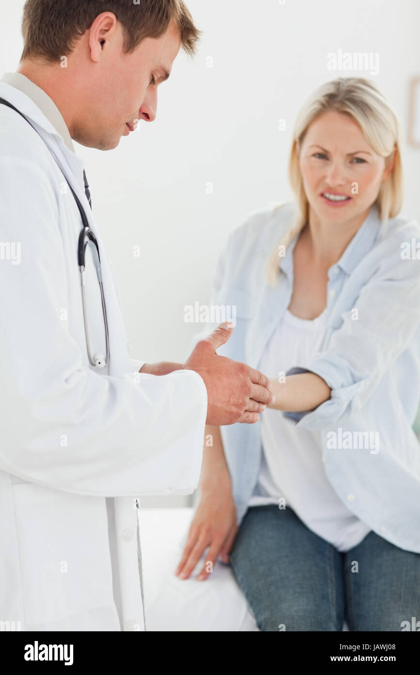Doctor checking his patients wrist Stock Photo - Alamy