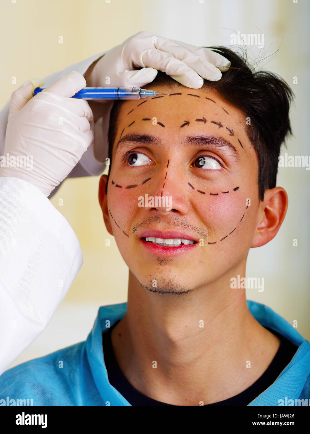 Closeup of a handsome young man, receiving facial cosmetic treatment ...