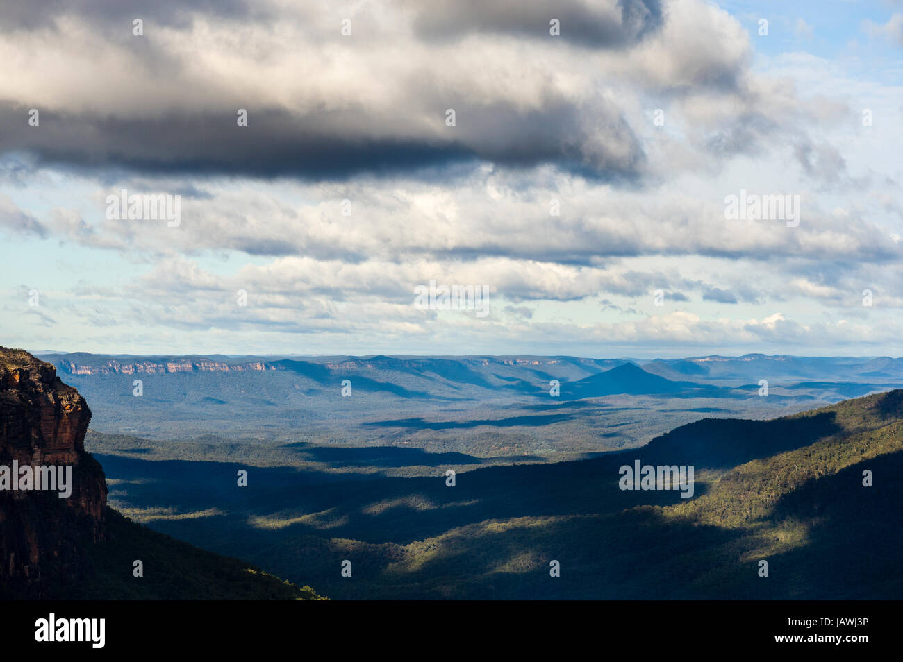 Storm clouds roll over a valley shrouded in dense forest Stock Photo ...