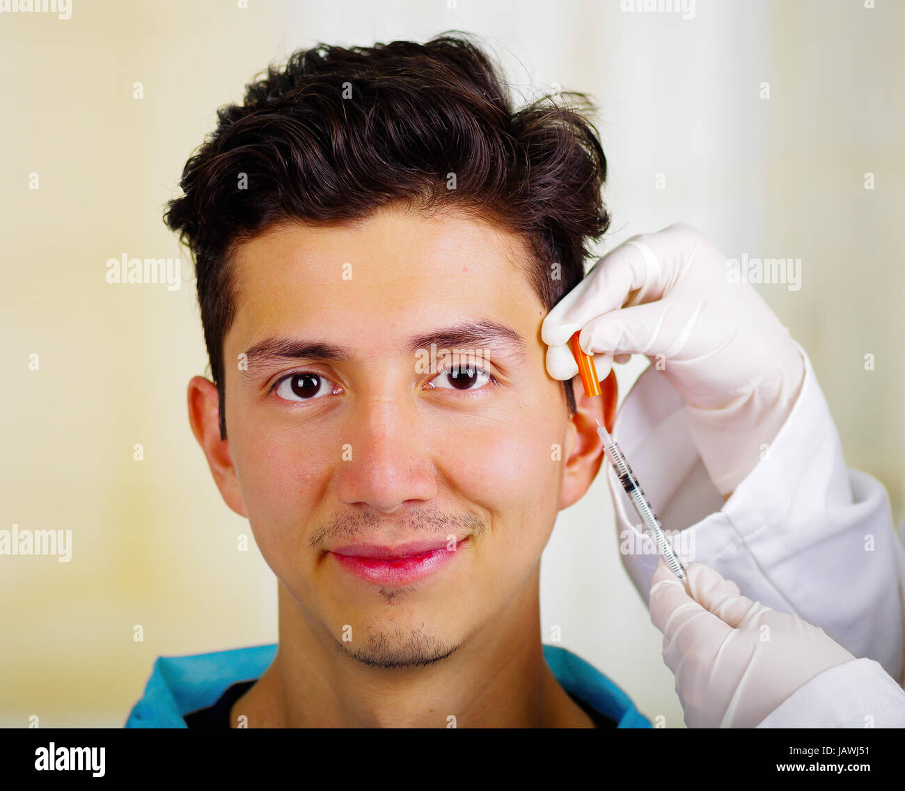Handsome young man, receiving facial cosmetic treatment injections ...
