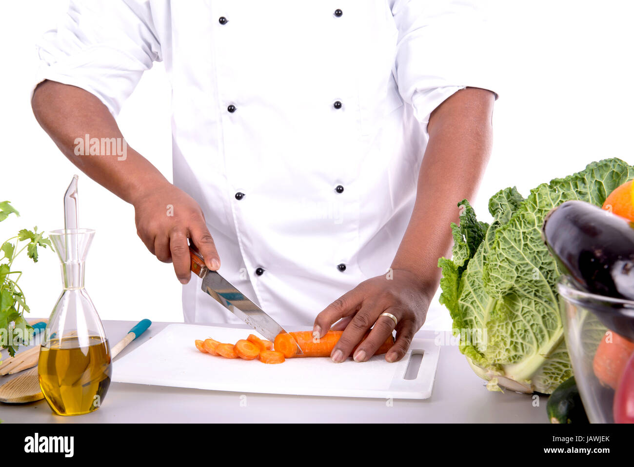 Male chef with fruits and vegetables on table, isolated on white ...