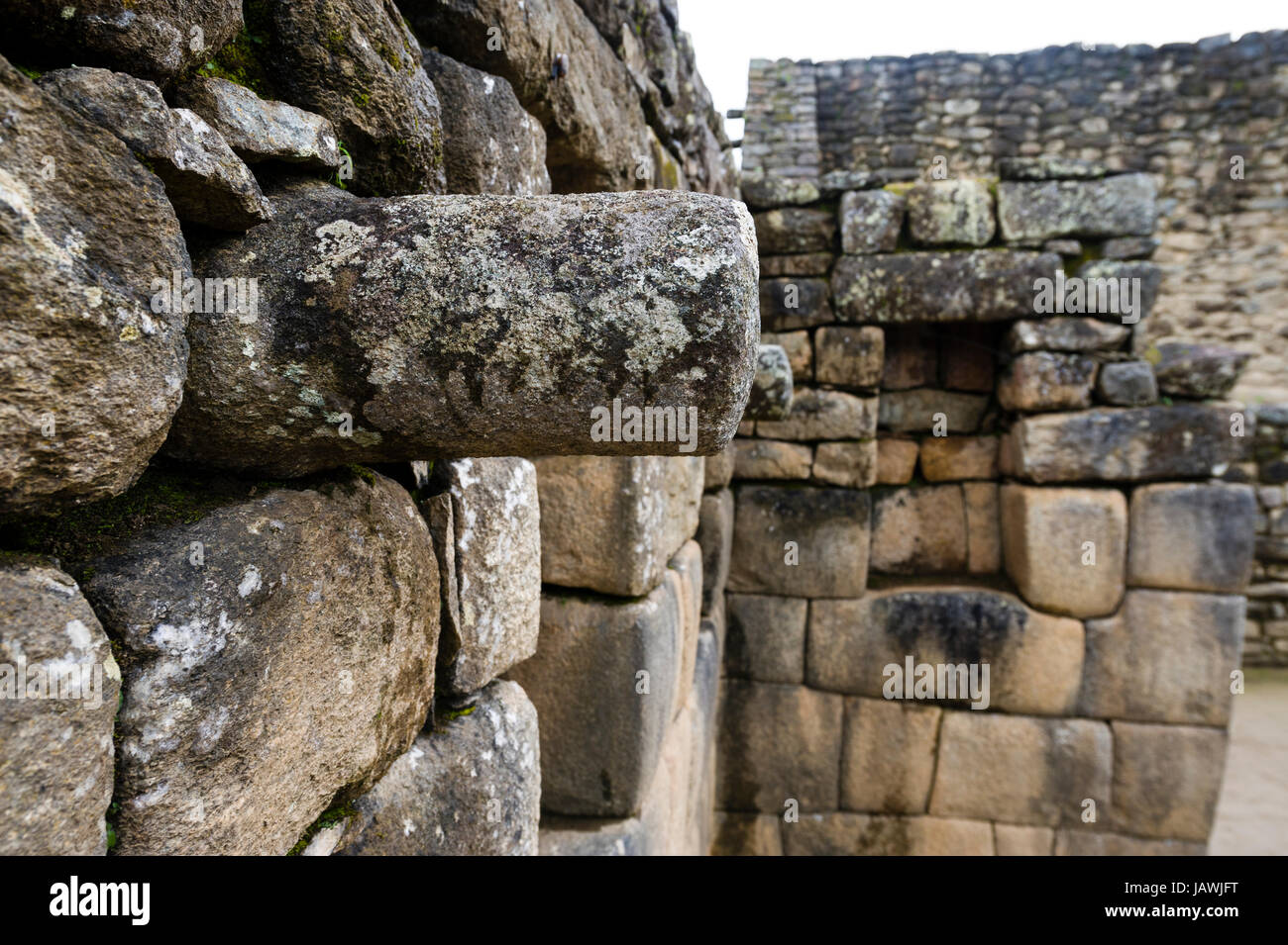 A stone joist emerges from a wall to support a ceiling in a Inca ...