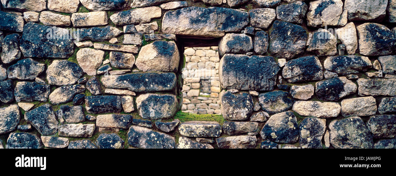 A window in a trapezoidal wall in a residential building at Macchu ...